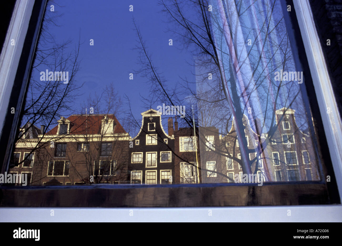 Europe, Netherlands, Amsterdam. Houses reflected in a window, typical ...