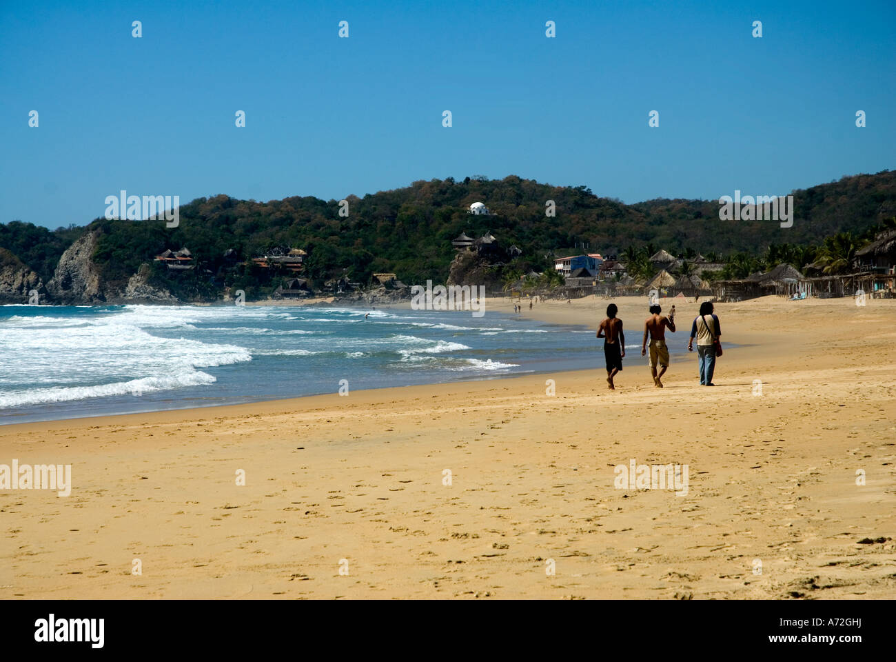 Zipolite - three guy walk on the beach - Mexico Stock Photo - Alamy