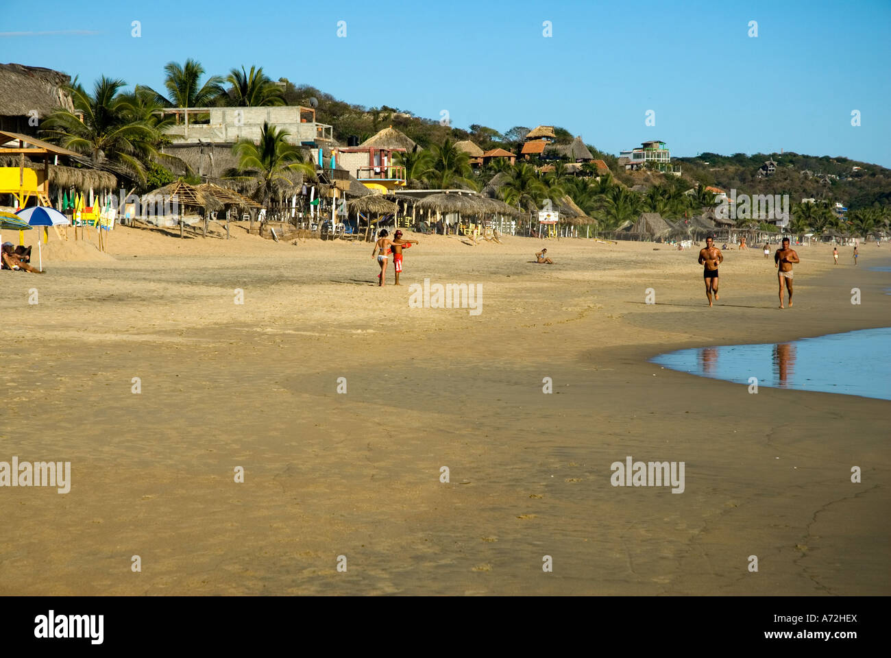 Zipolite - two man walking on the beach - Mexico Stock Photo - Alamy