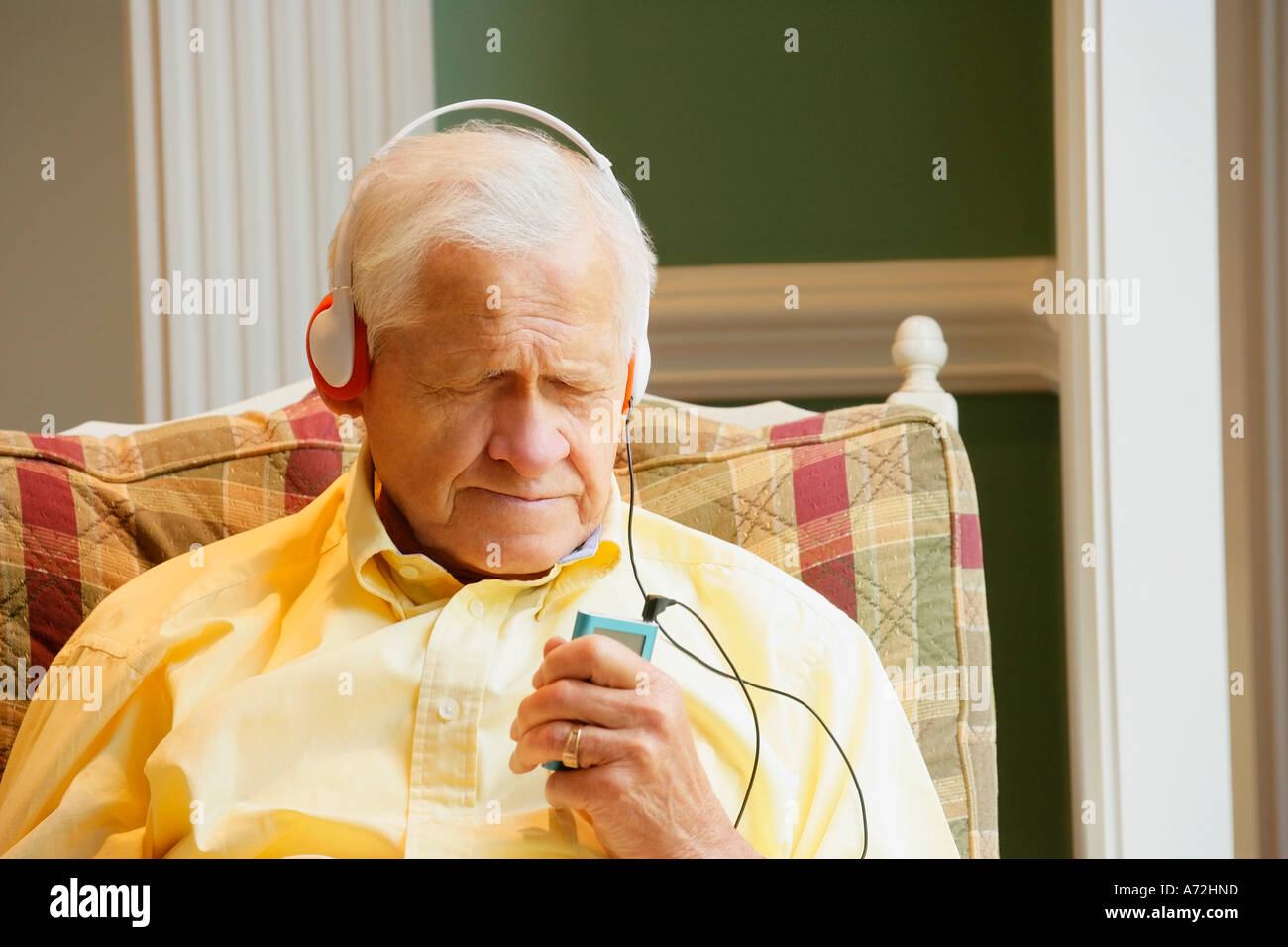 Senior listens to audio player Stock Photo - Alamy