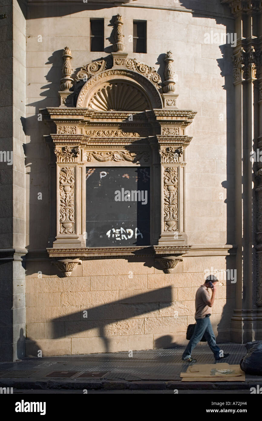 Man on mobile telephone cast shadows early evening light Buenos Aires ...