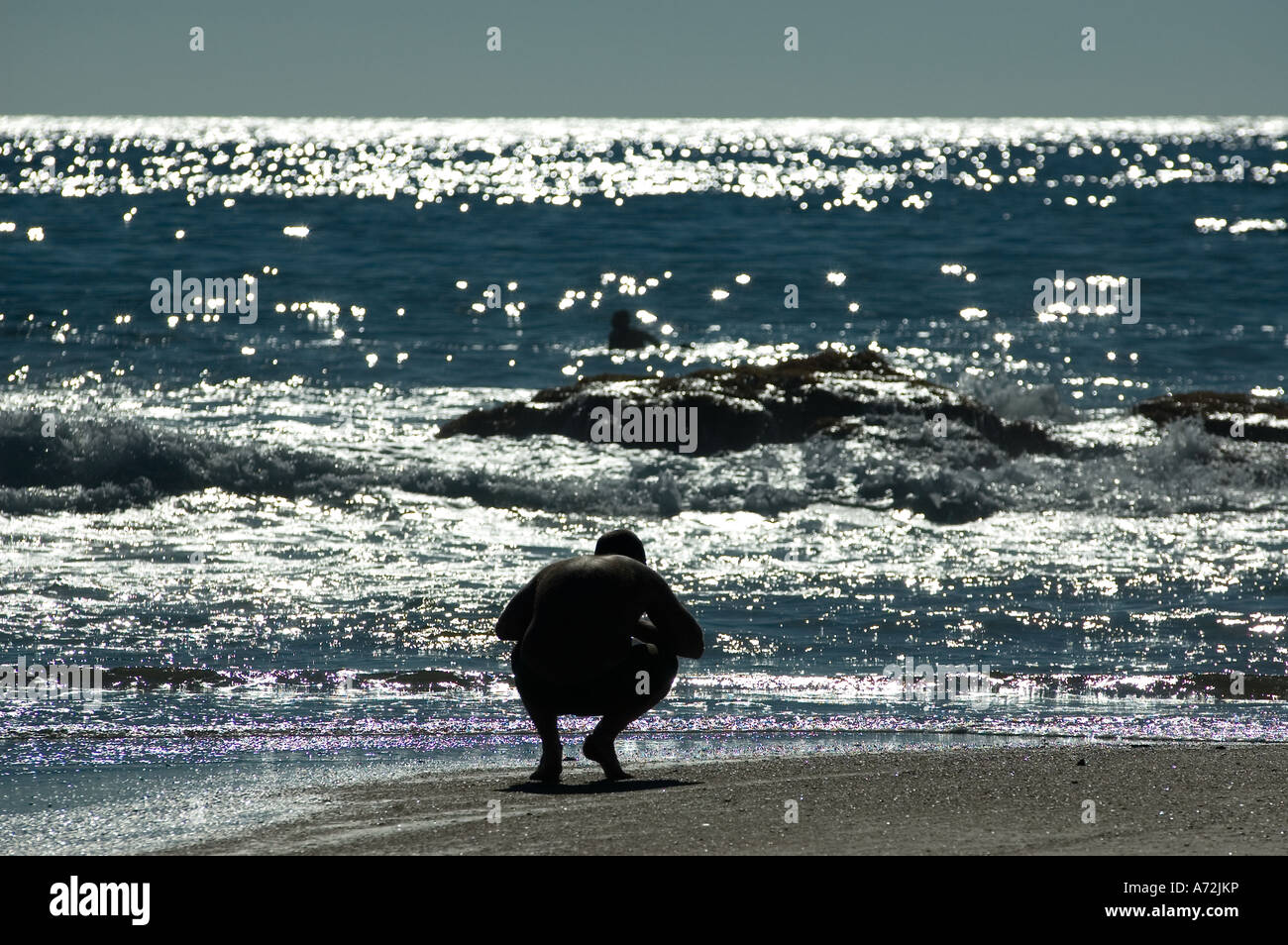 Zipolite - man pick up shells from the sand - Oaxaca - Mexico Stock ...