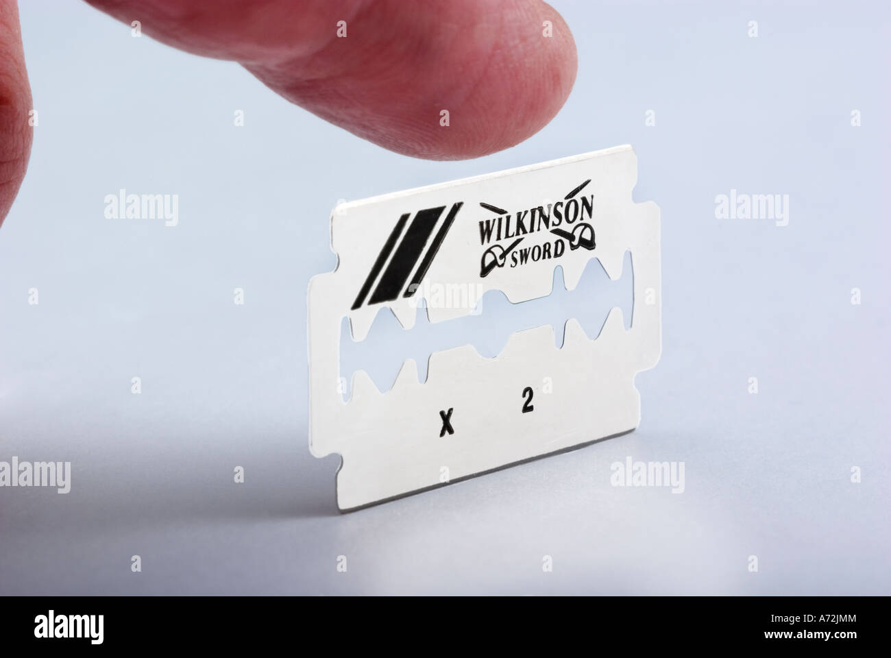 Graphic image of old fashioned razor blade with finger on edge Stock ...