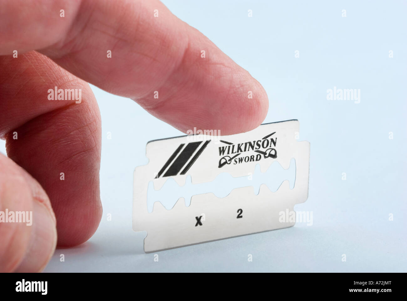 Graphic image of old fashioned razor blade with finger on edge Stock ...