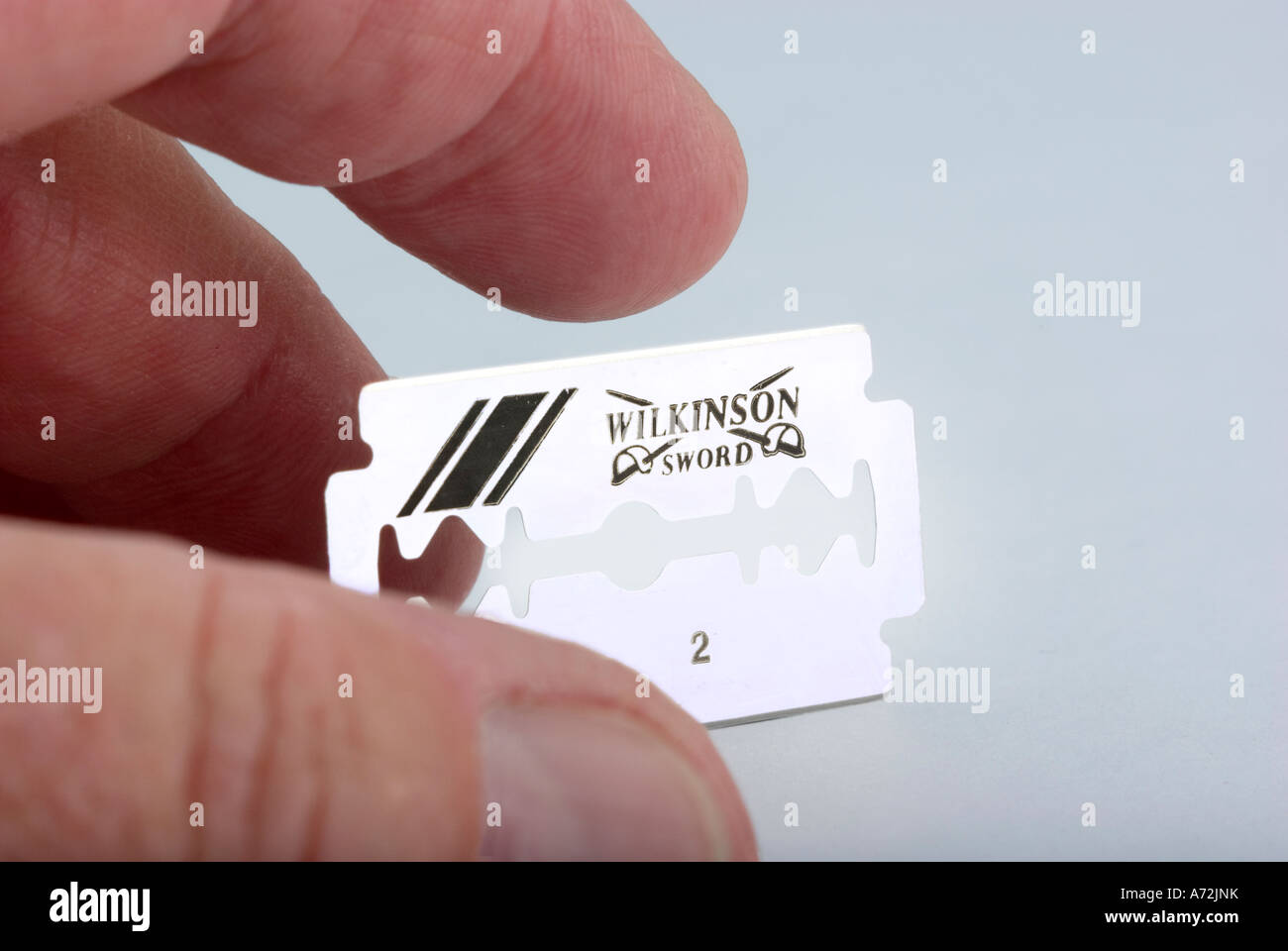 Graphic image of old fashioned razor blade with finger on edge Stock ...