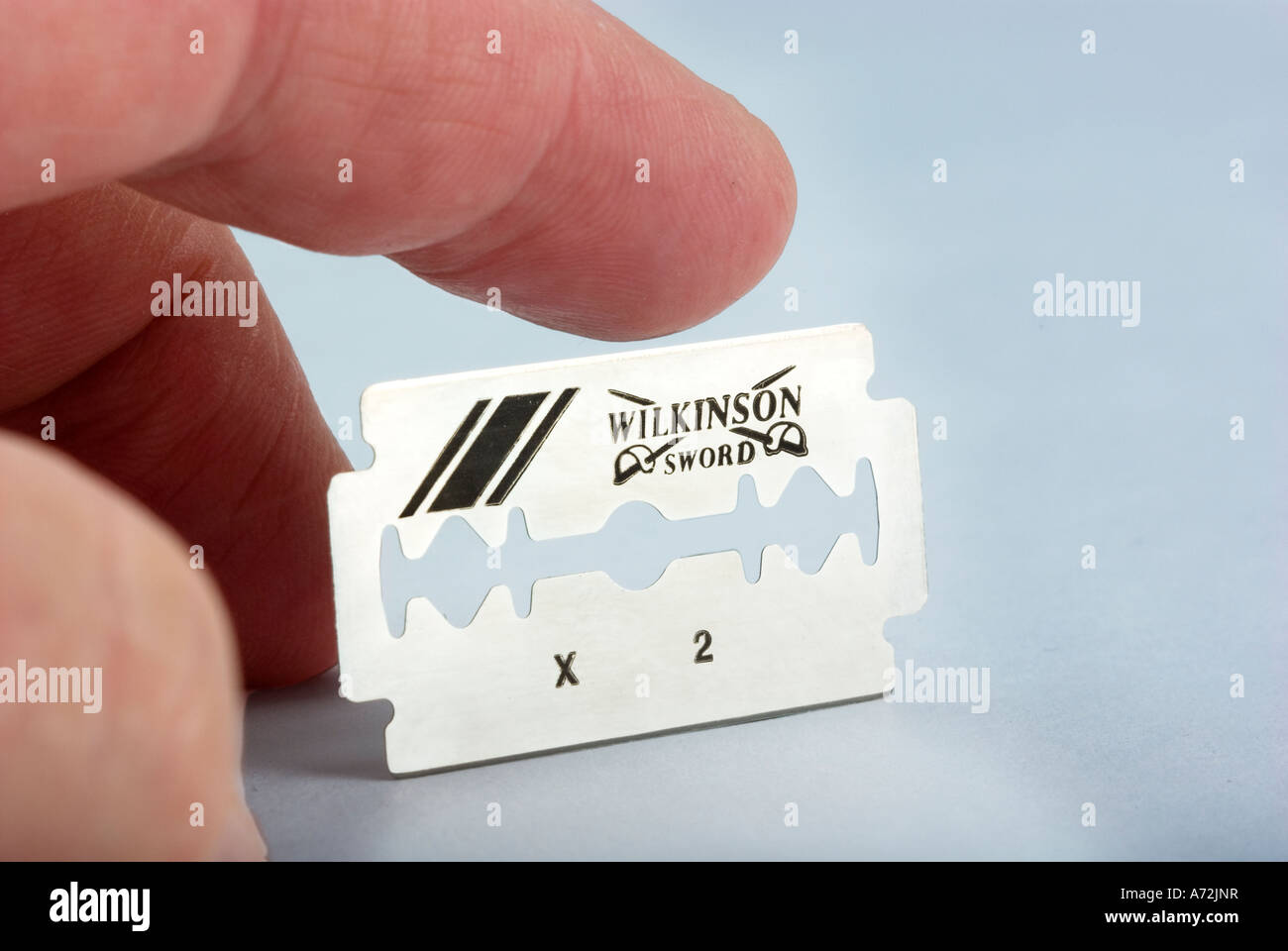 Graphic image of old fashioned razor blade with finger on edge Stock ...