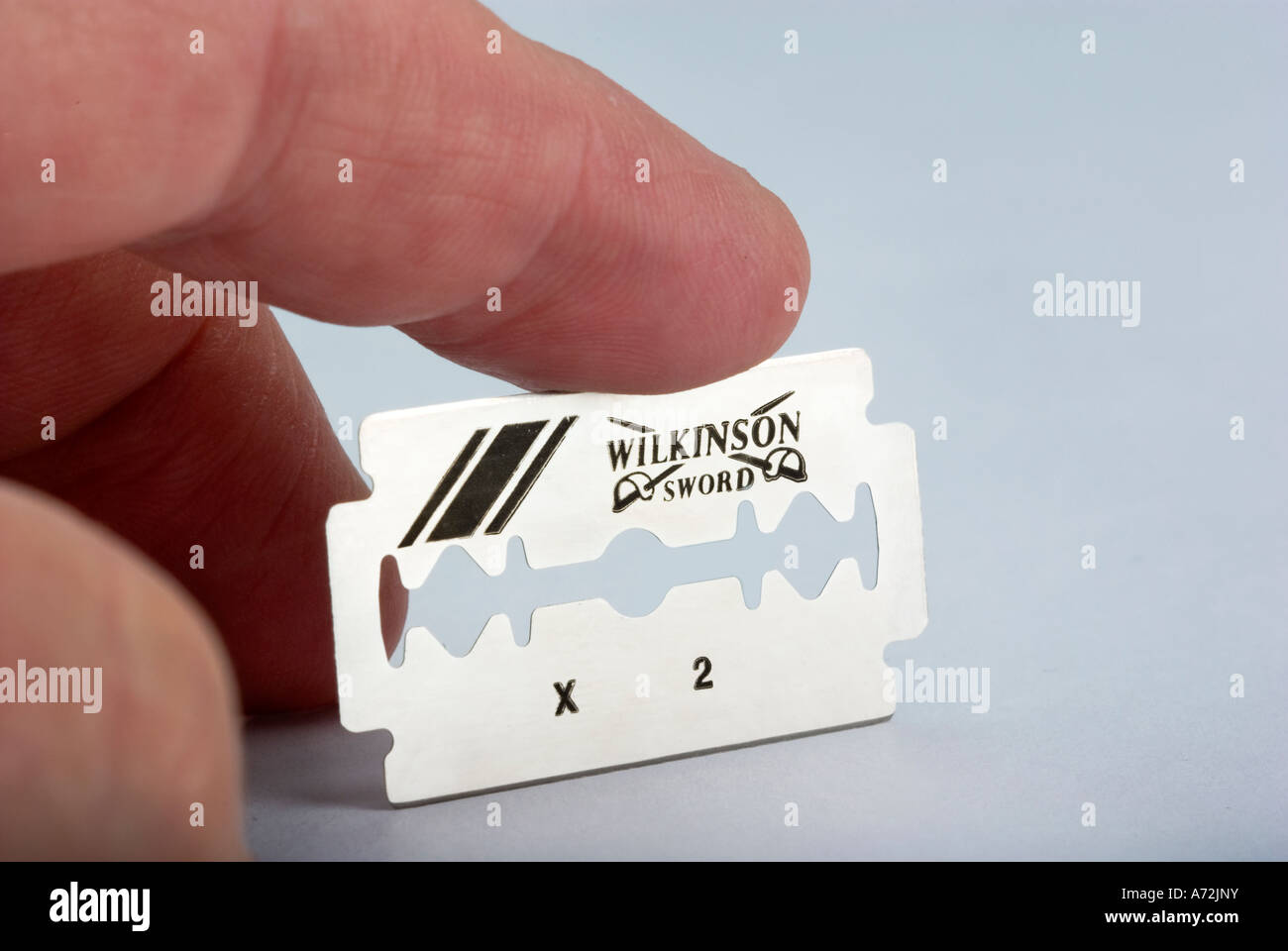 Graphic image of old fashioned razor blade with finger on edge Stock ...