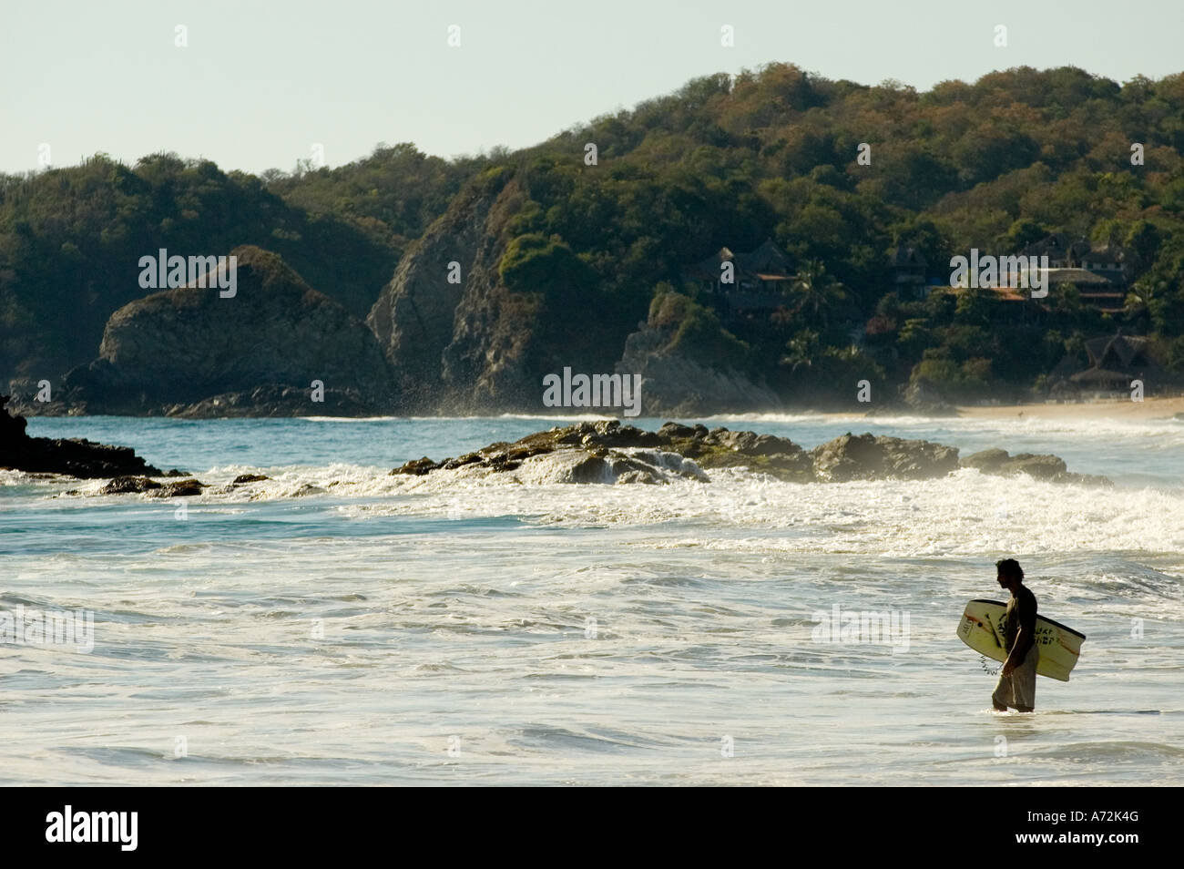 Zipolite surfer in the water - Oaxaca - Mexico Stock Photo - Alamy