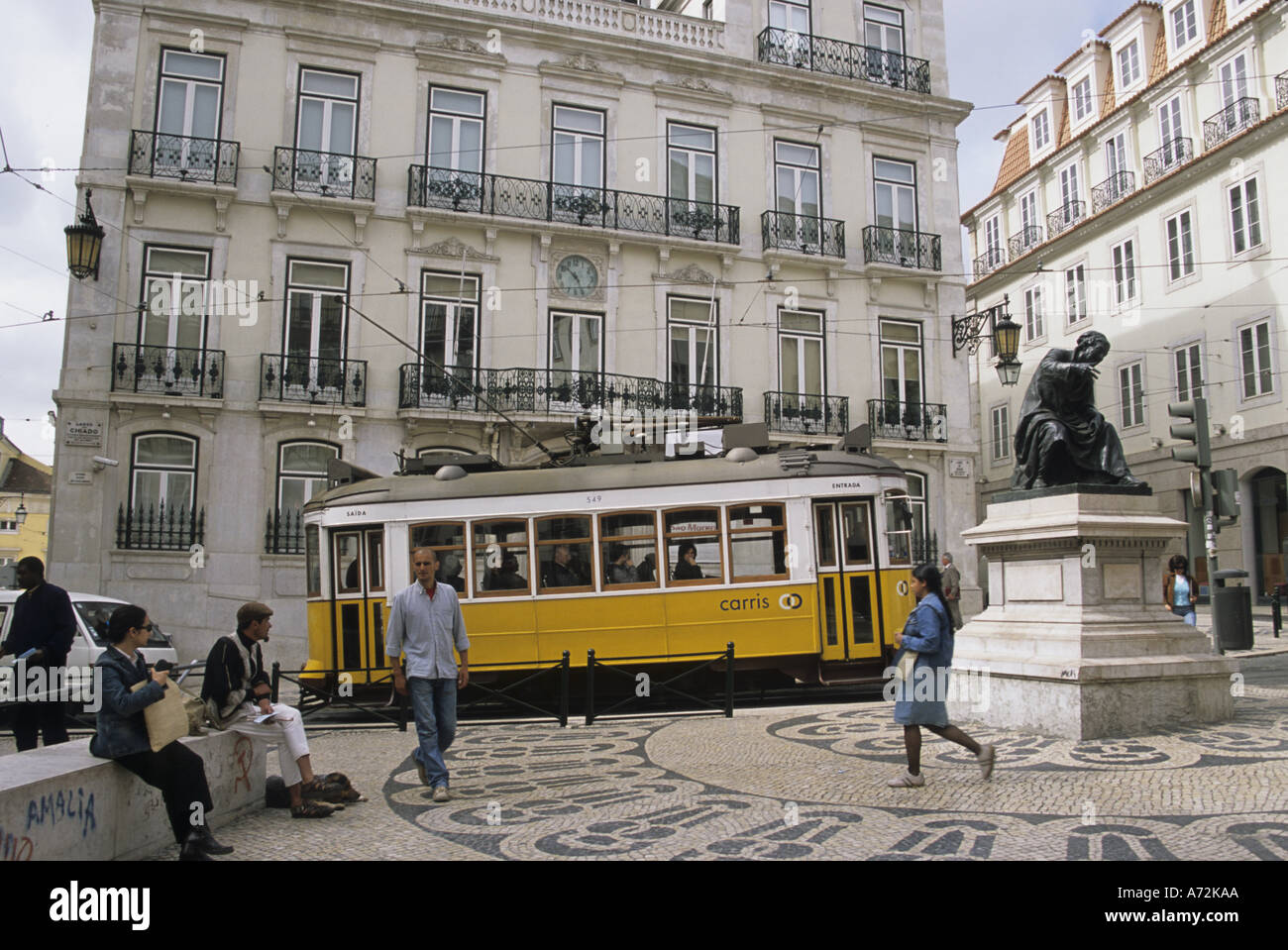 Europe, Portugal, Lisbon. Yellow trolley (tram), elaborate cobblestone ...