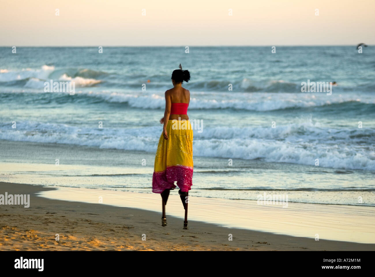 Zipolite sunset - woman on stilts walk on the sand - Oaxaca - Mexico ...