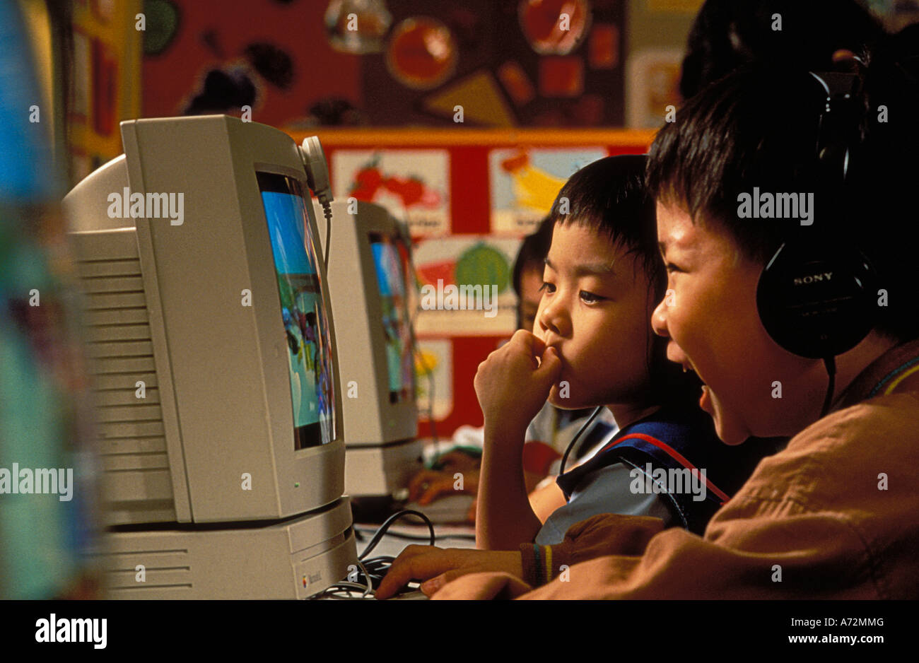 Two young asian boys playing and learning on computers Stock Photo - Alamy