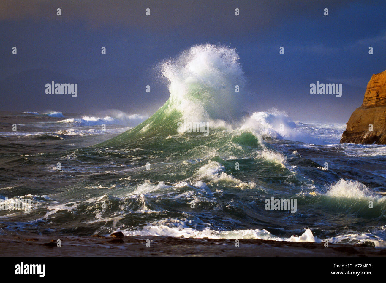Wave crashing distant storm Cape Kiwanda Stock Photo - Alamy