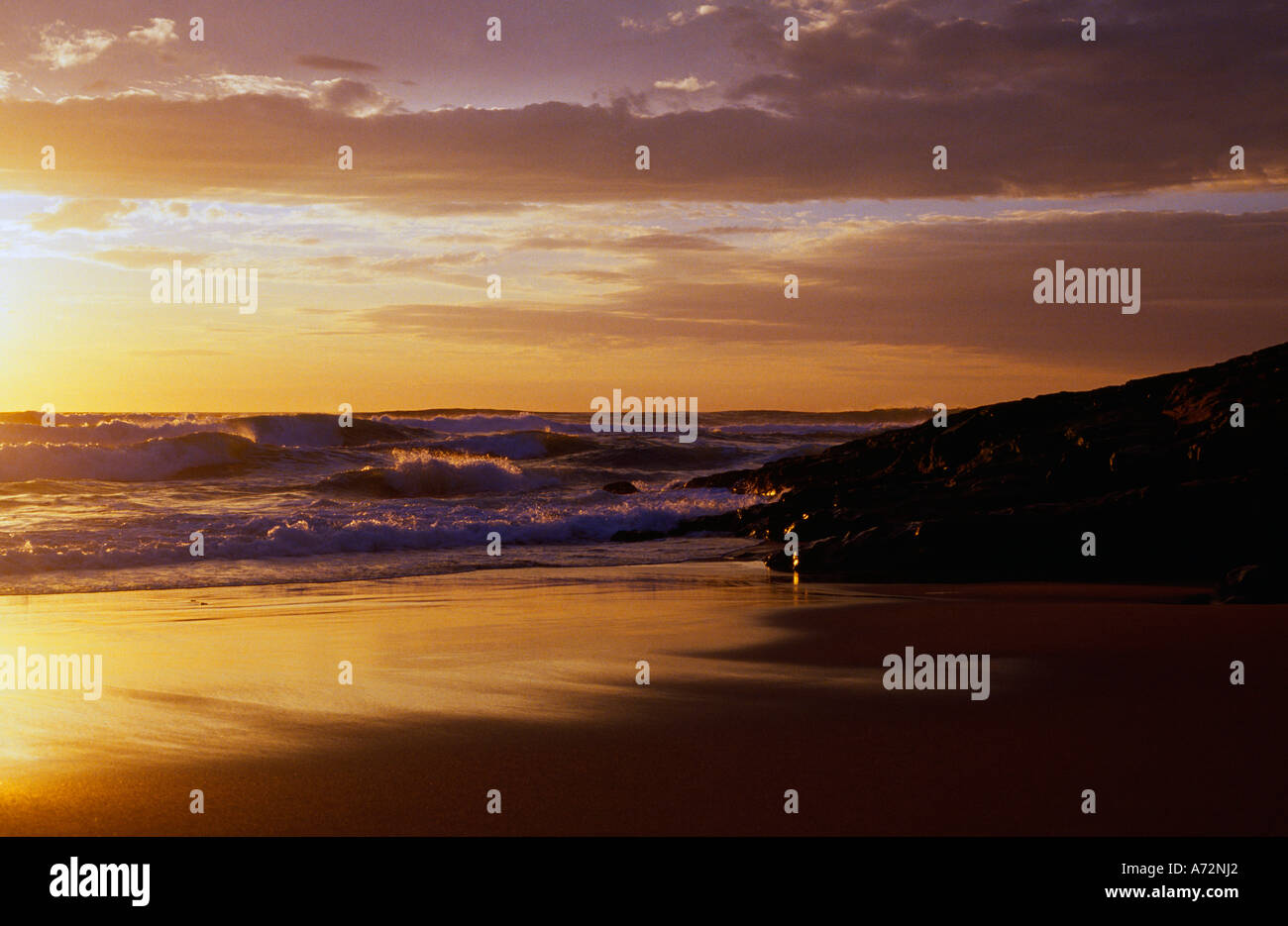 Beach waves and sky in golden light Stock Photo - Alamy