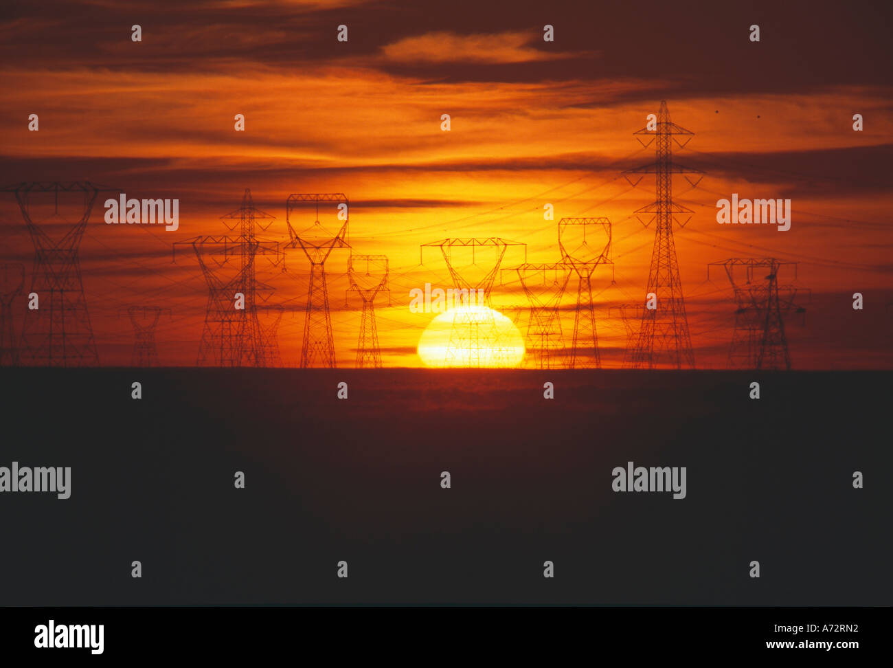 Powerline silhouettes at sunset Stock Photo - Alamy