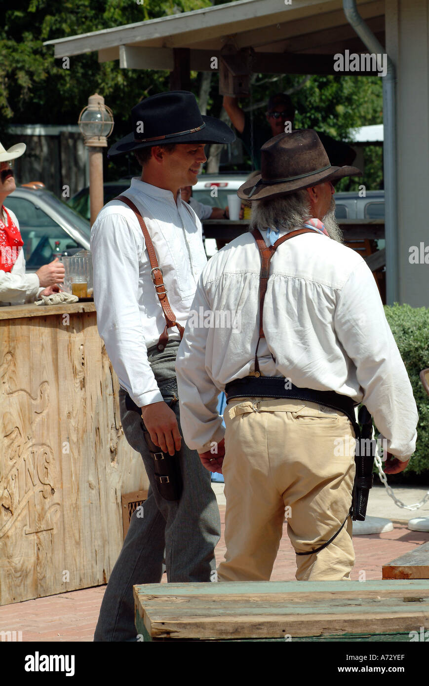 two men acting cowboys wearing typical clothes Stock Photo - Alamy
