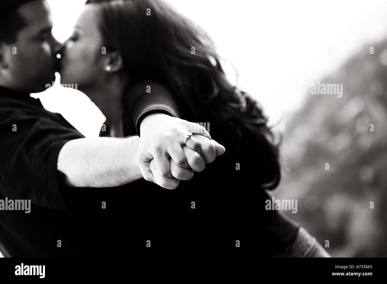 Engaged Couple Kissing Stock Photo - Alamy