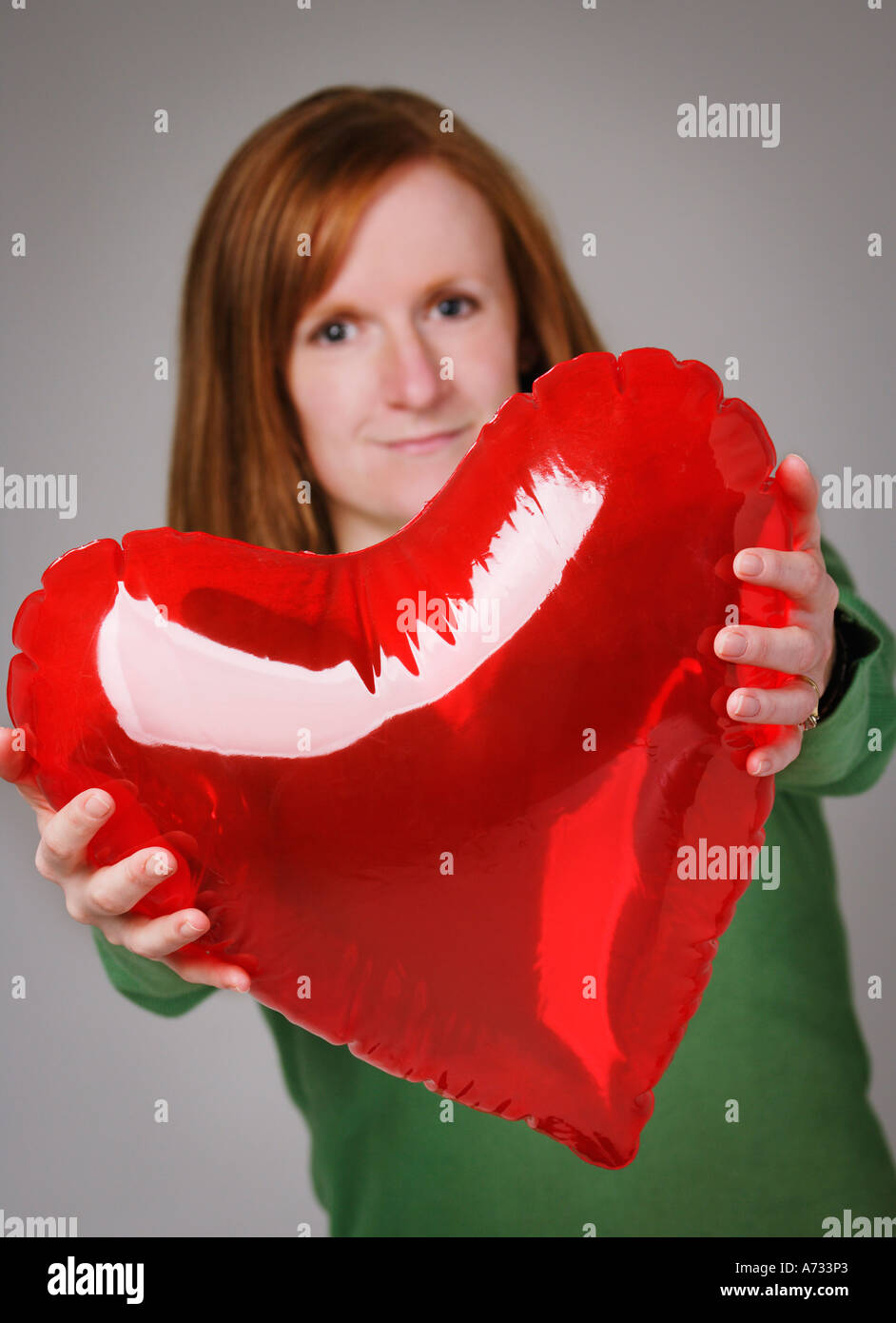 Woman giving heart Stock Photo - Alamy