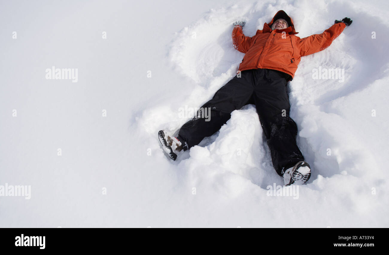 Boy making snow angel Stock Photo - Alamy