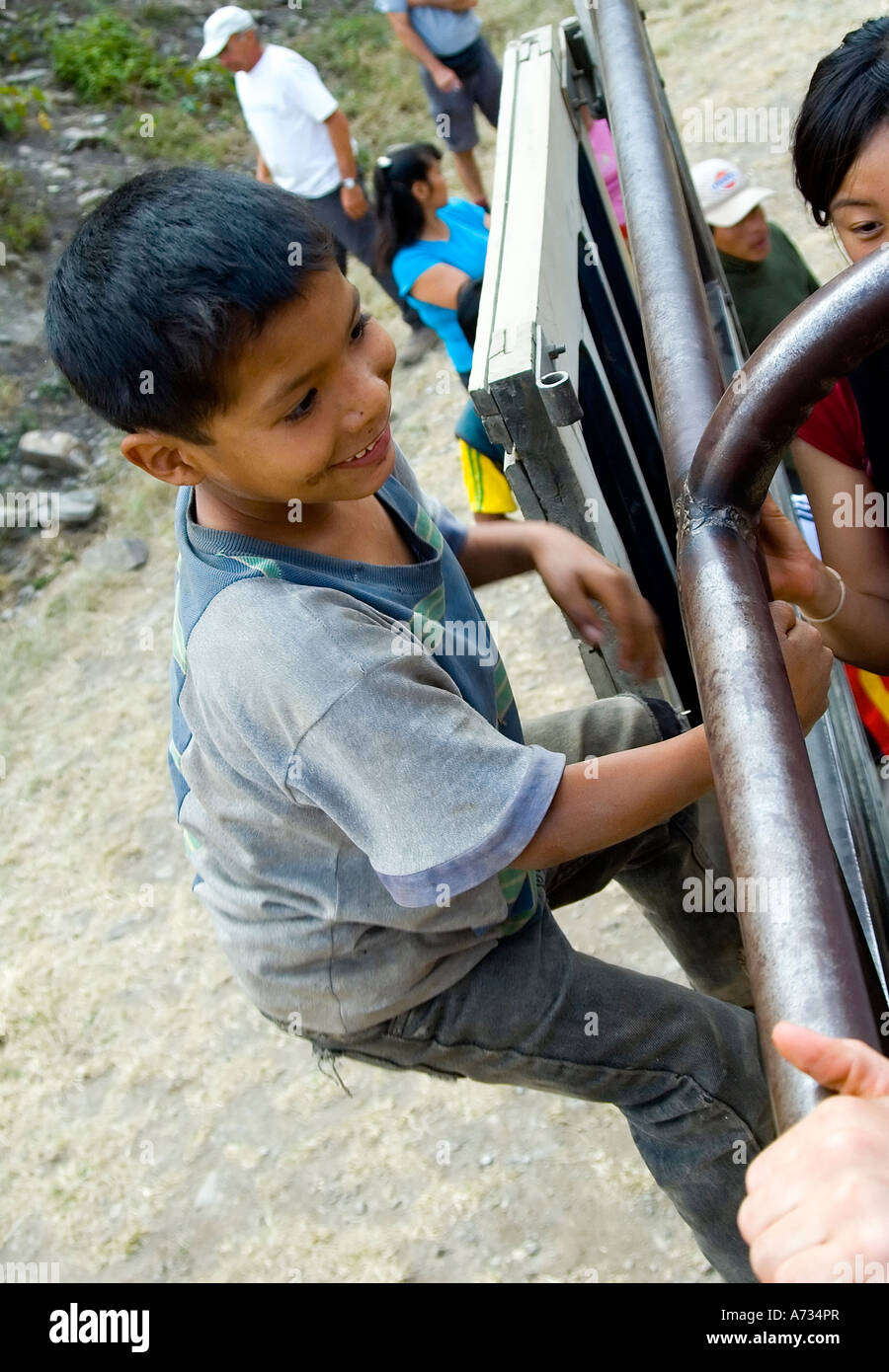 Young Peruvian boy climbing on a truck. Peru Stock Photo - Alamy