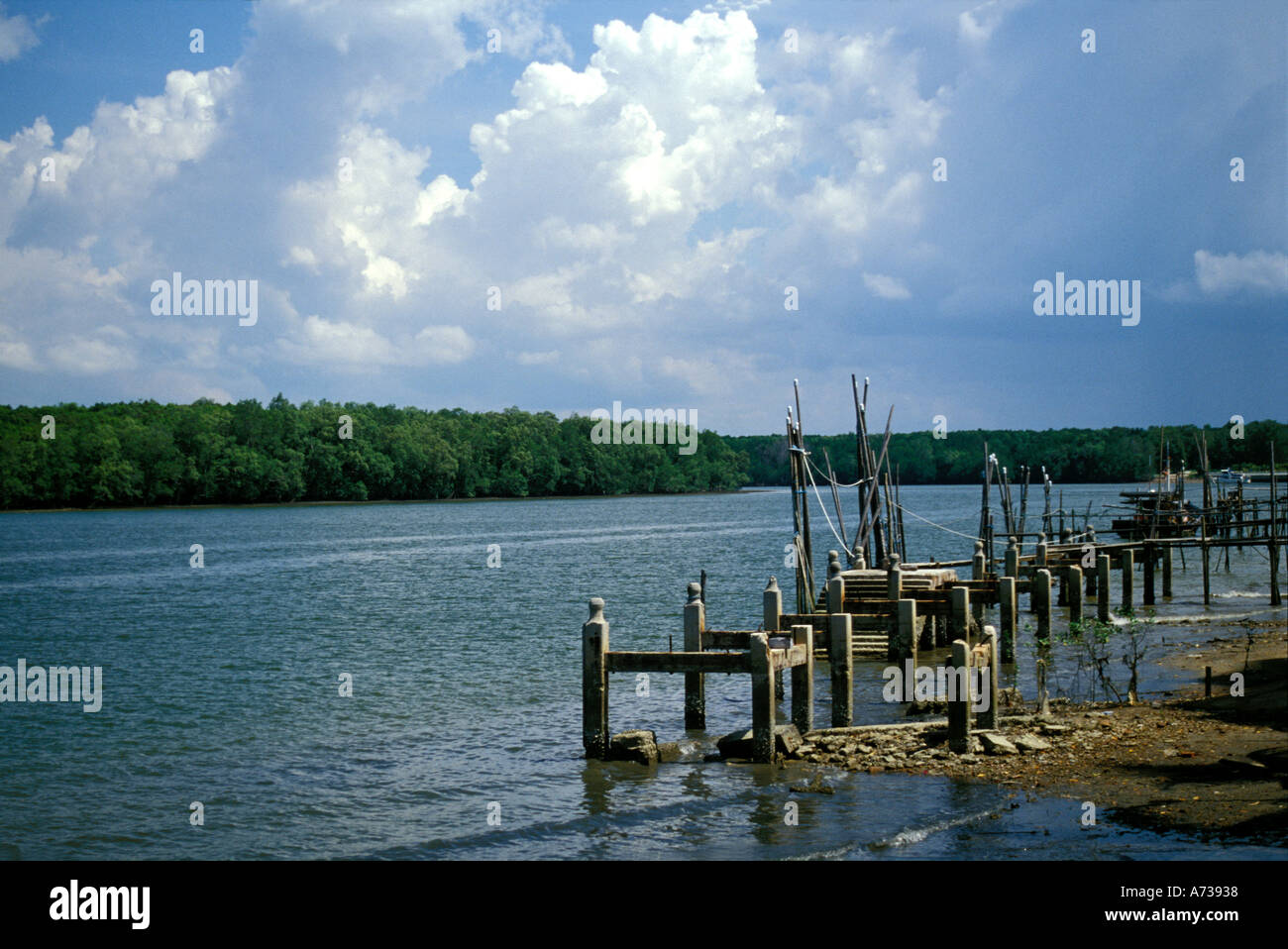 broken down stone jetty at river mouth Stock Photo - Alamy