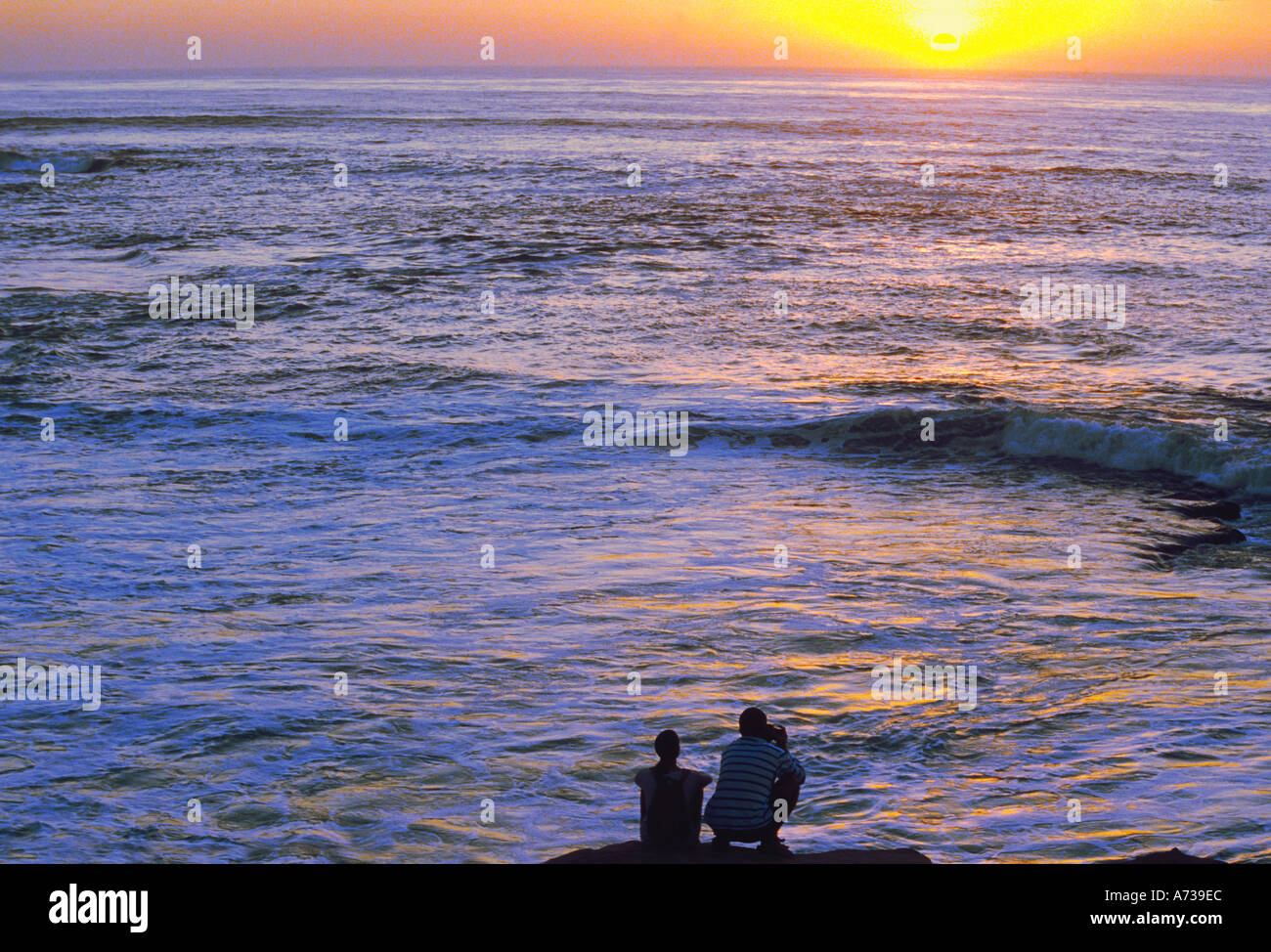 CALIFORNIA La Jolla Couple sit rocks watch sunset over Pacific Ocean ...