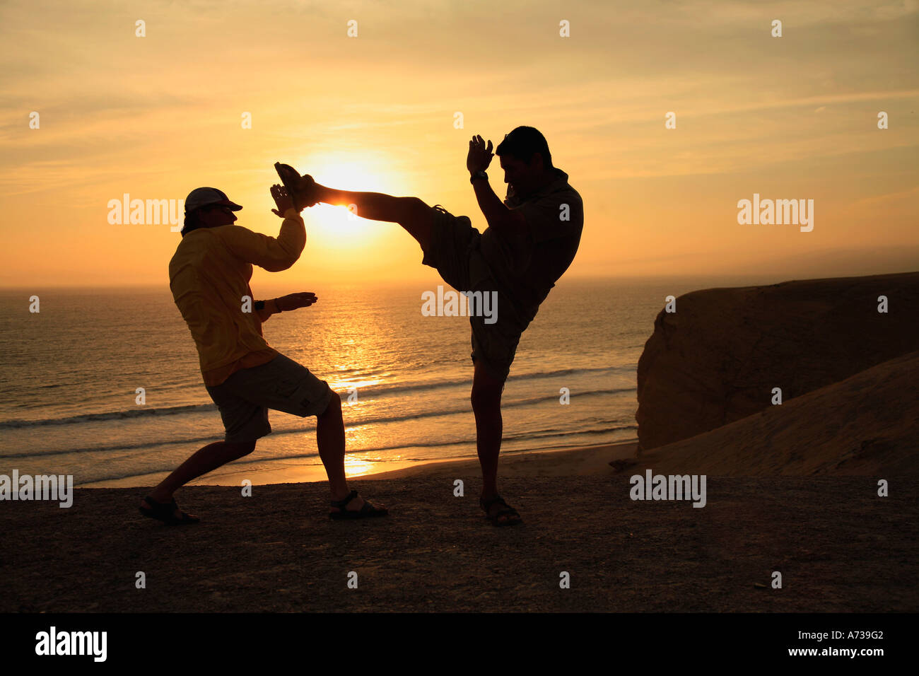 Fighting by the beach Stock Photo - Alamy