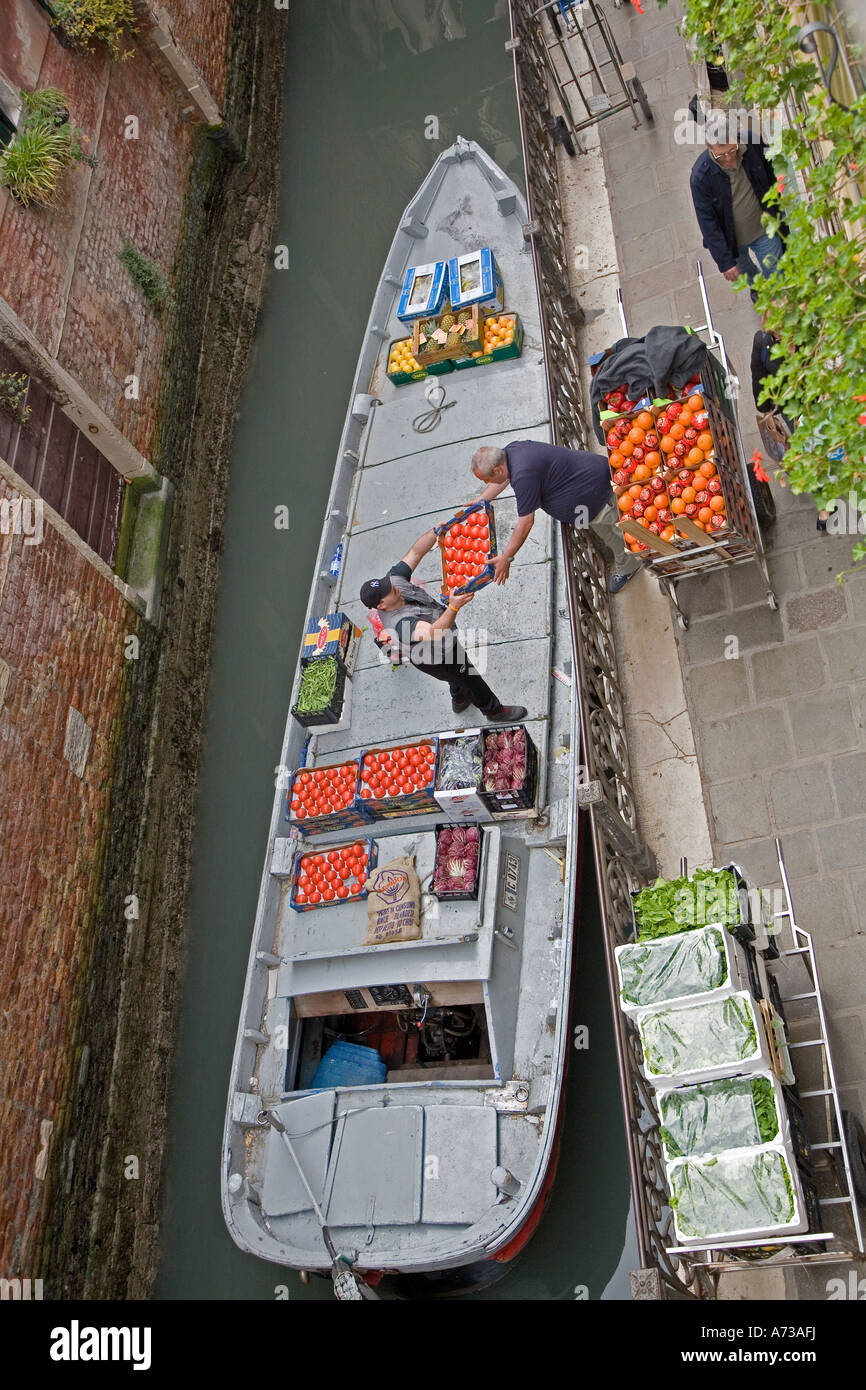 Canal barge offloading goods to hotel complex Stock Photo - Alamy