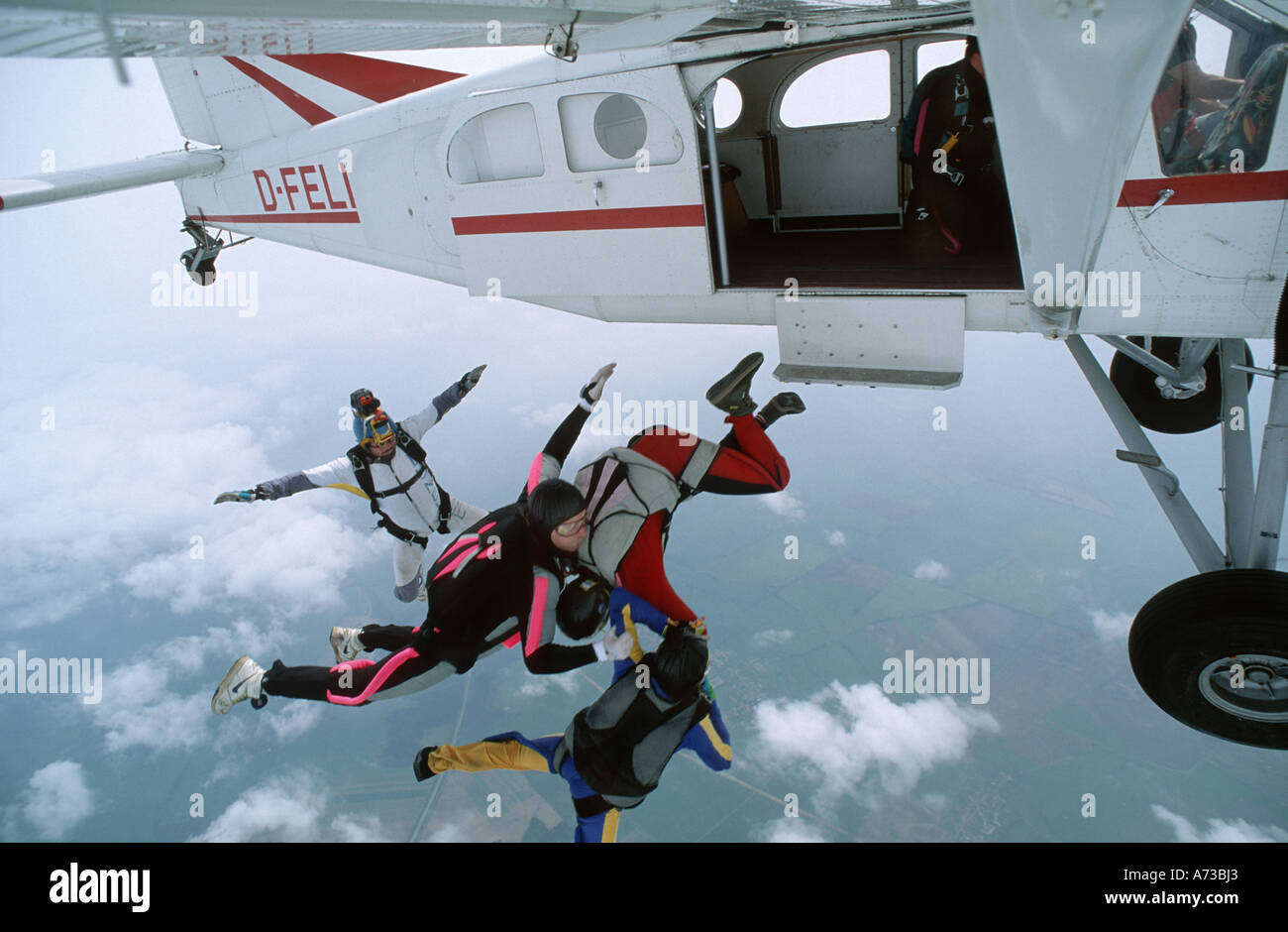 four sky divers jumping out of sports aeroplane, Germany, Brandenburg ...