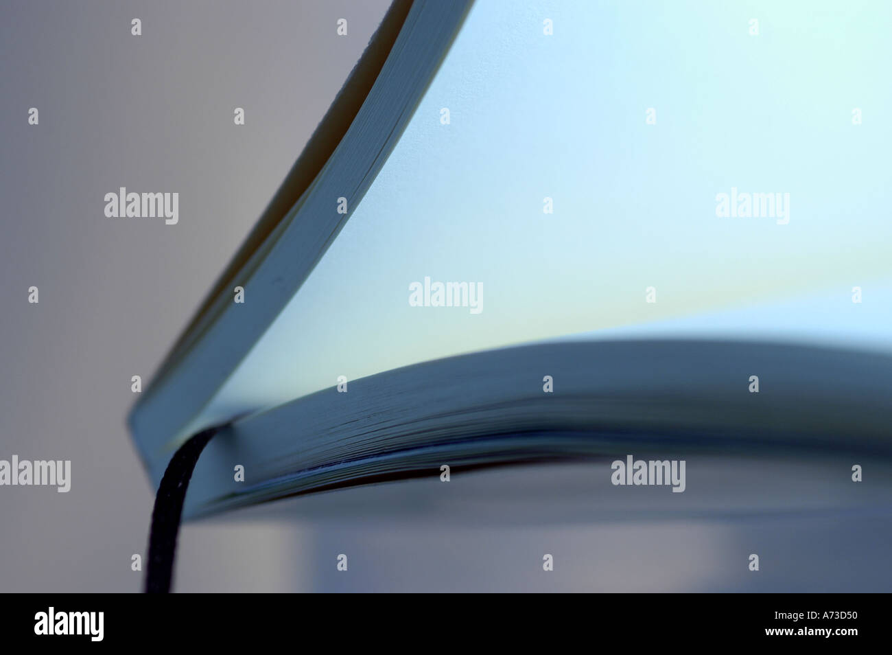 Slightly opened notebook black ribbon bookmark blue Stock Photo - Alamy