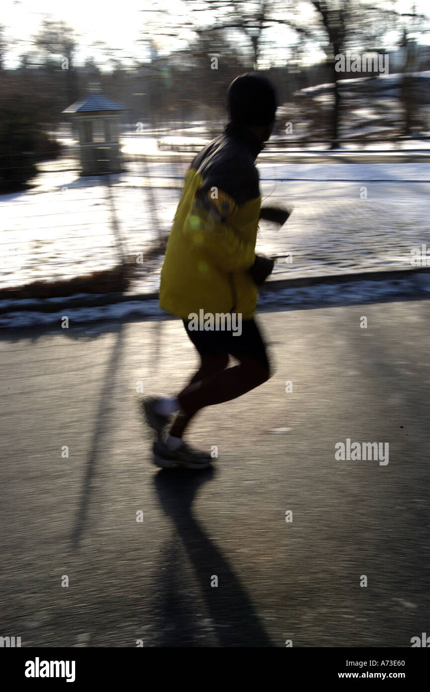 Runner yellow shirt jogging daylight Stock Photo - Alamy