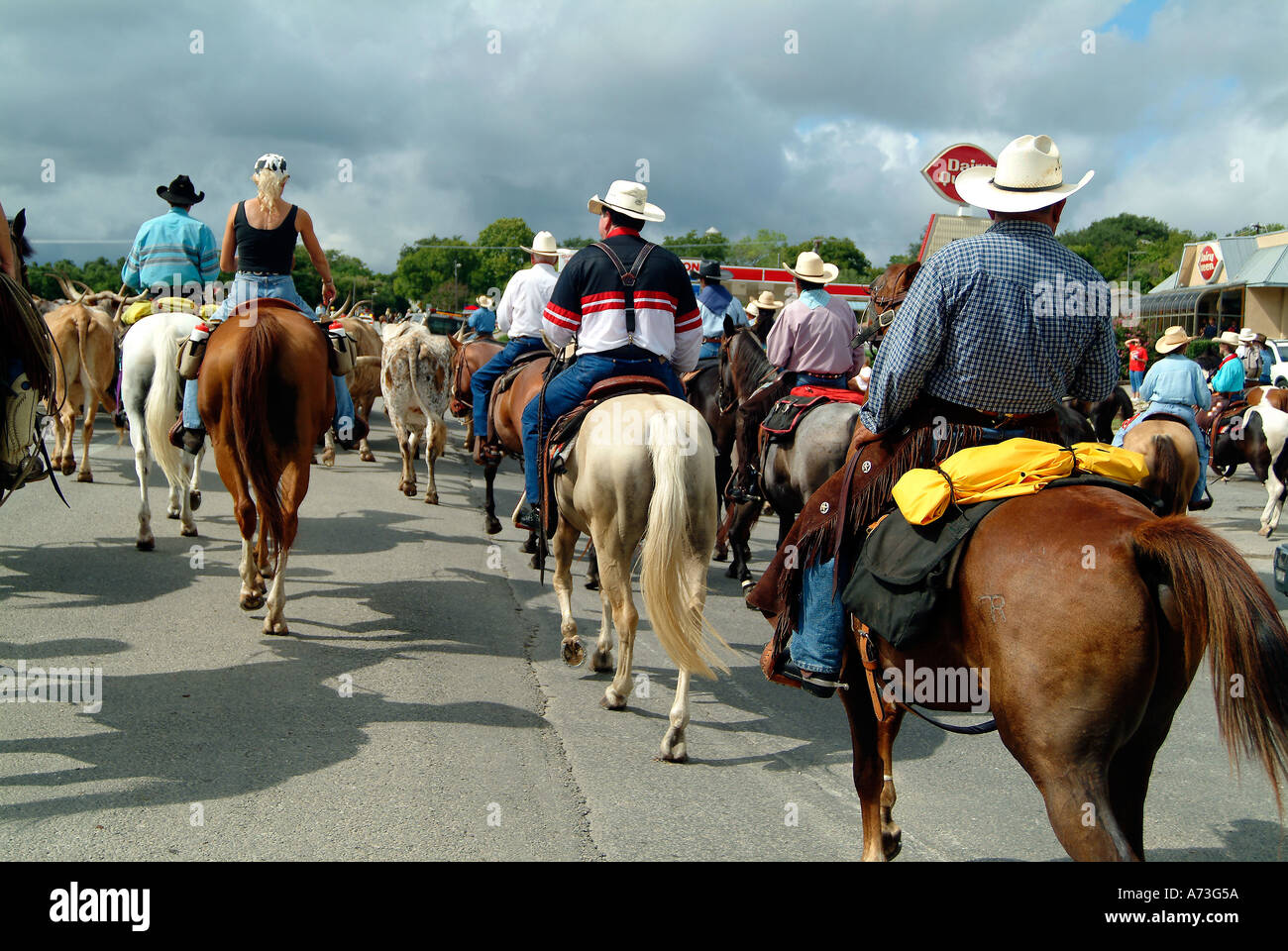 Group of cowgirls and cowboys riding horses in Bandera Texas Stock ...