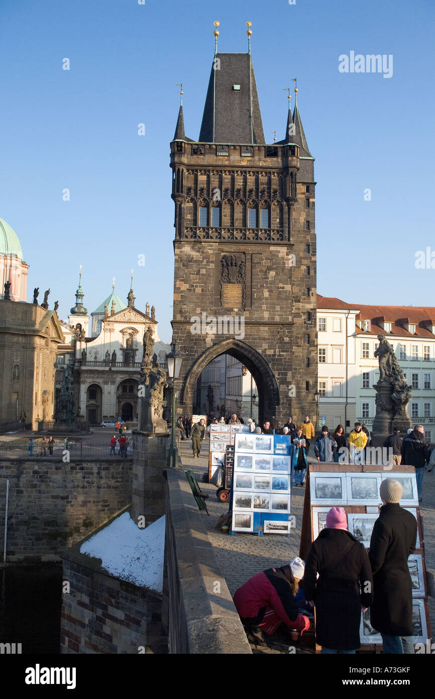Artists at work for the tourists souvenirs on Charles Bridge which ...