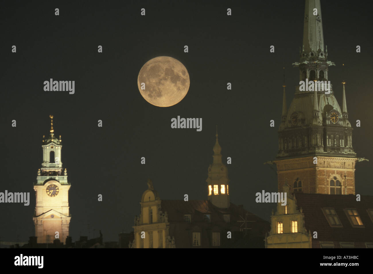 Sweden, Stockholm. Spectacular full moon rises between the church ...