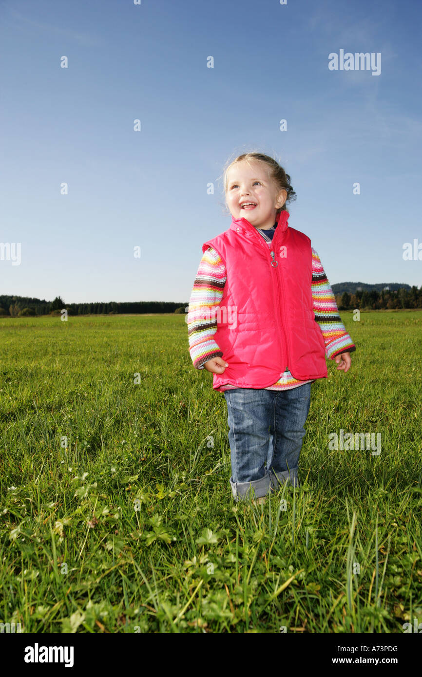 little girl standing in field Stock Photo - Alamy