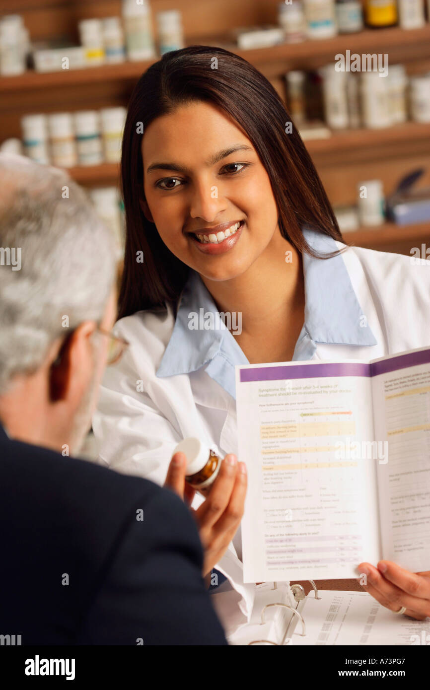Pharmacist explains instructions on medication Stock Photo - Alamy