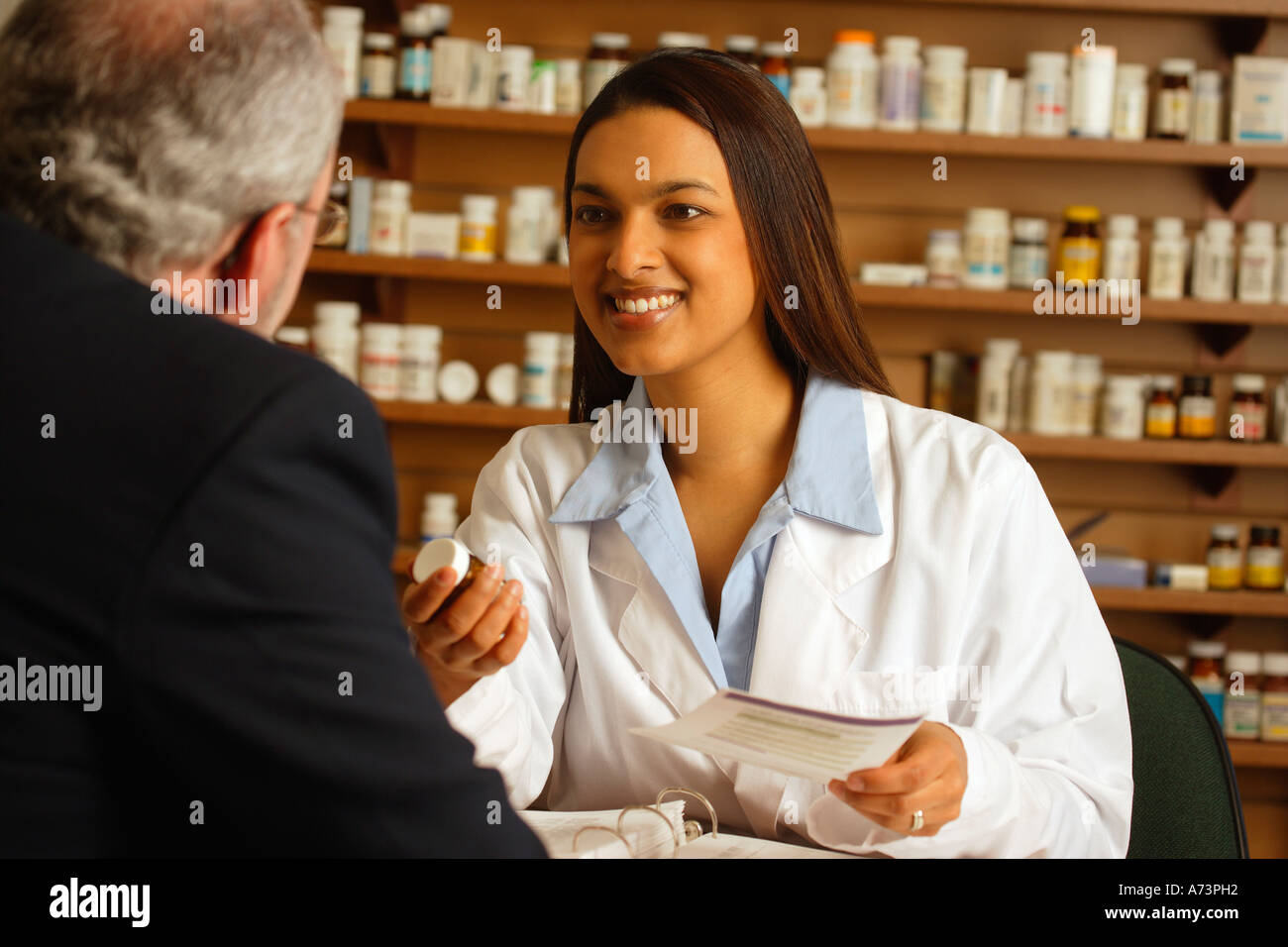 A pharmacist with a patient Stock Photo - Alamy