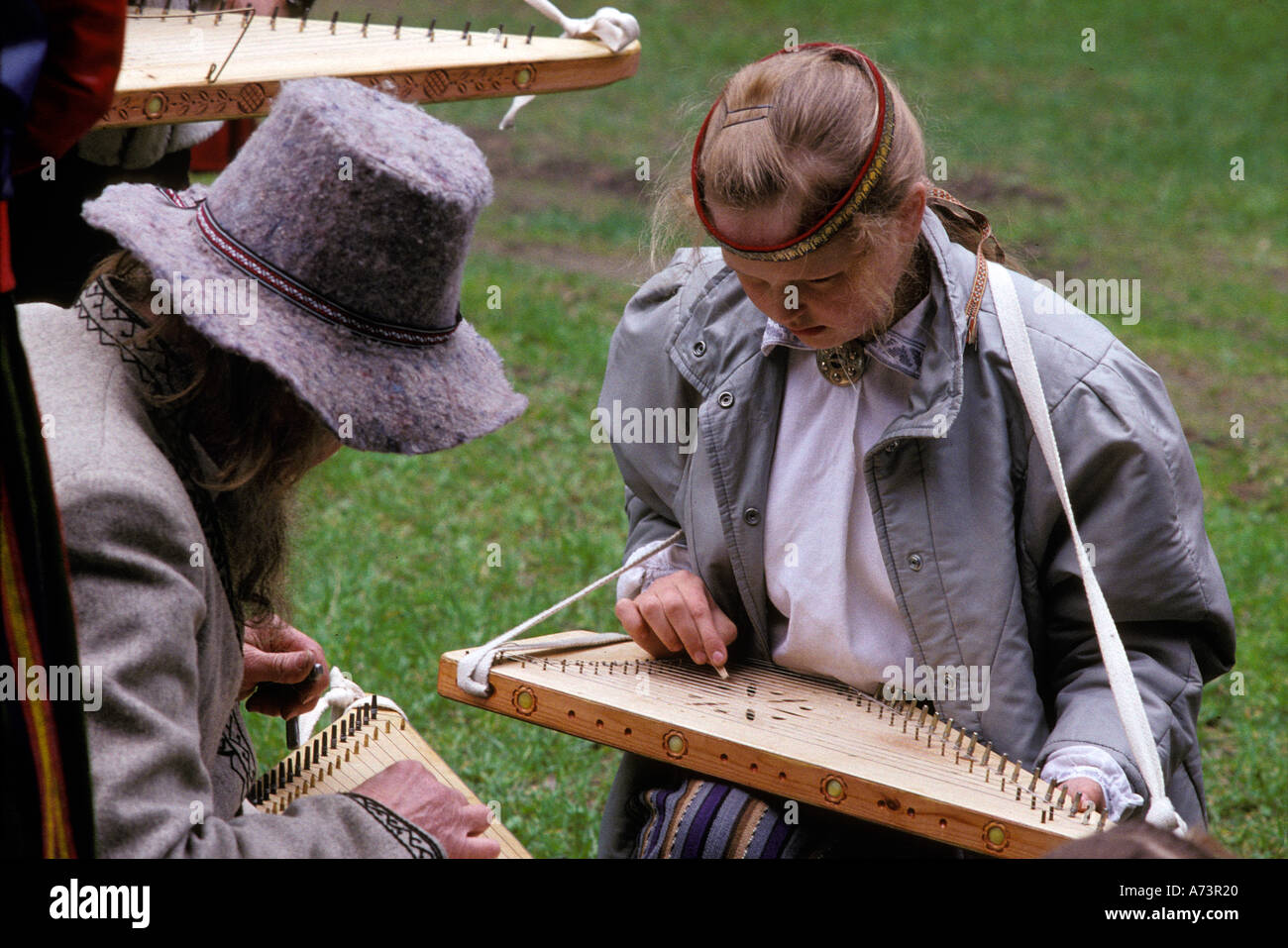 Student playing on kokle instrument during festival at the Open-Air ...