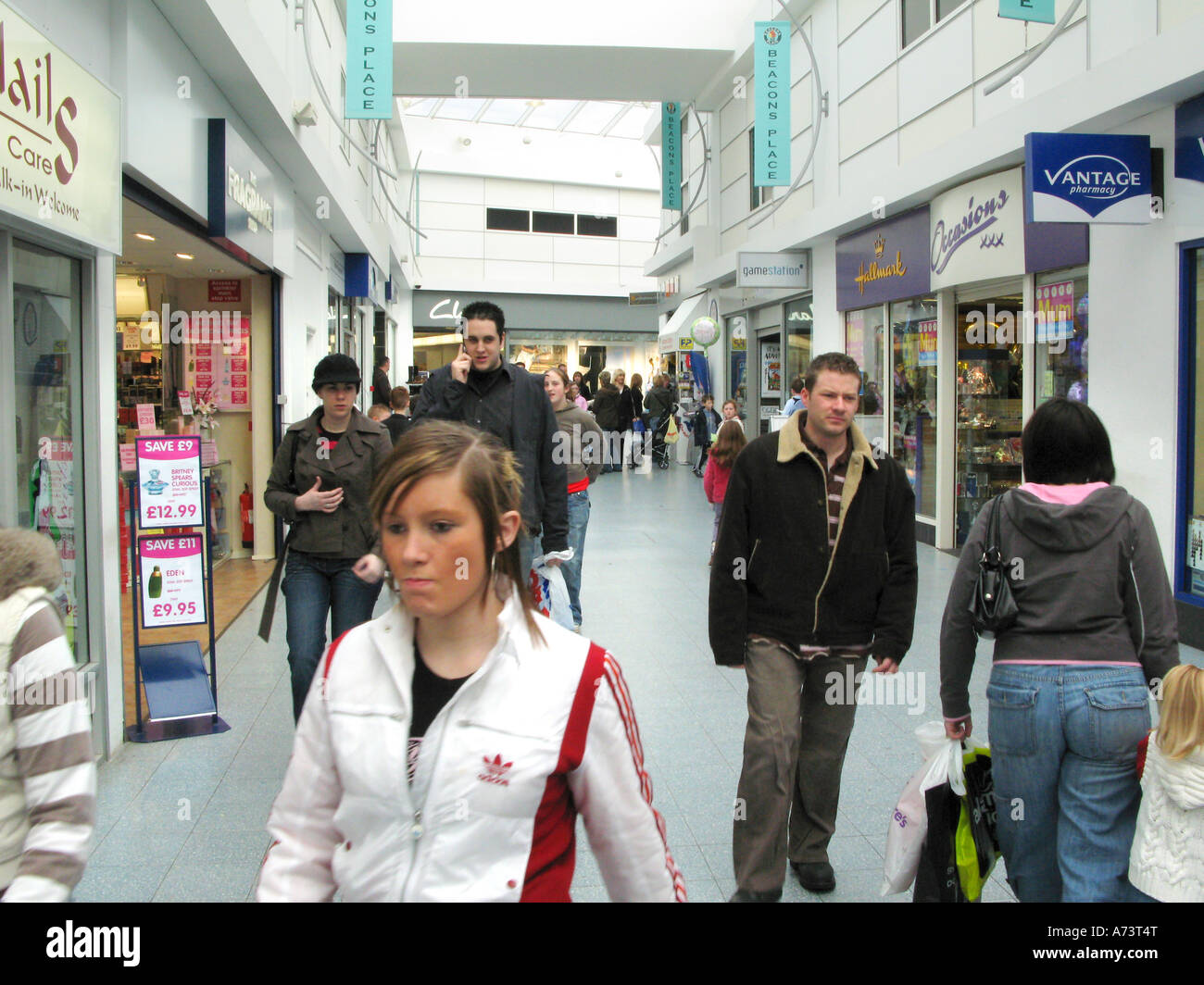 Shoppers stroll through modern shopping arcade in Merthyr Tydfil South ...