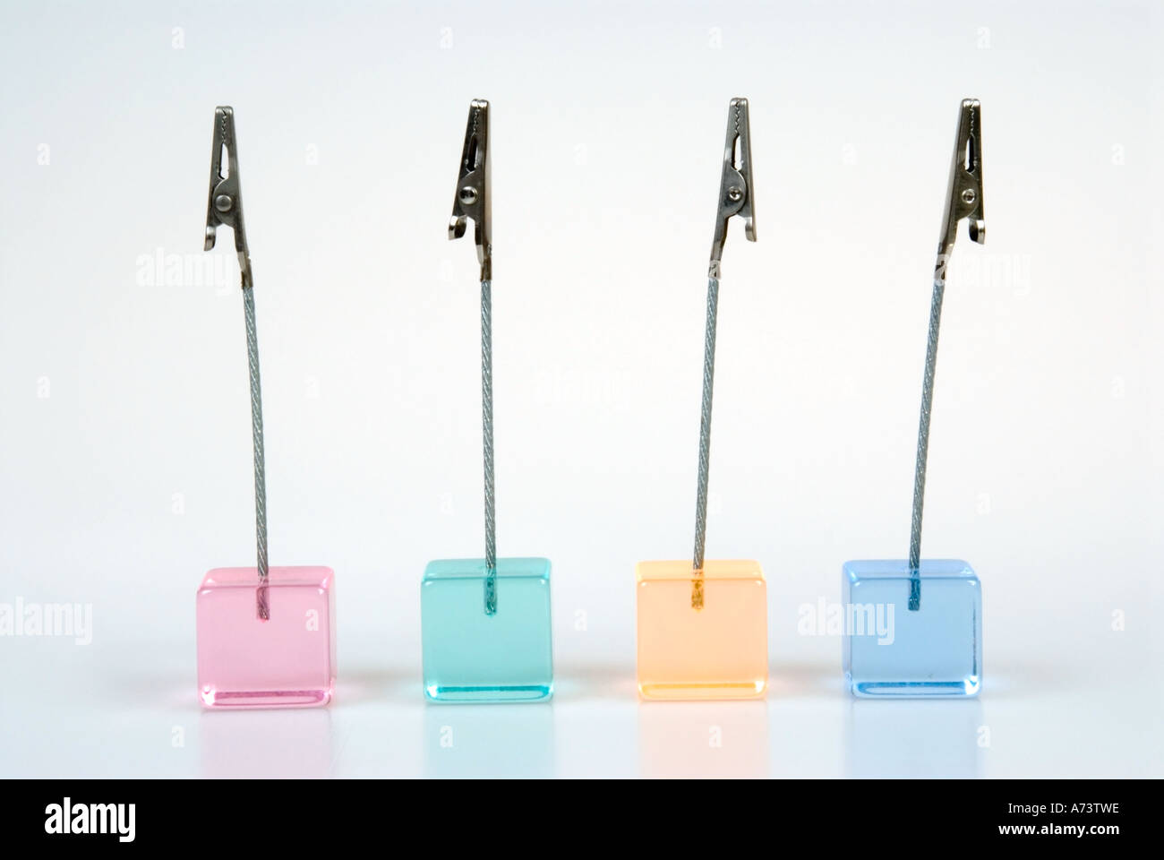 Four acrylic block note holders against a white background in line ...