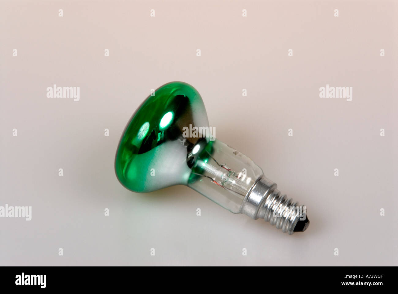 Green spotlight bulb side on against white background Stock Photo - Alamy