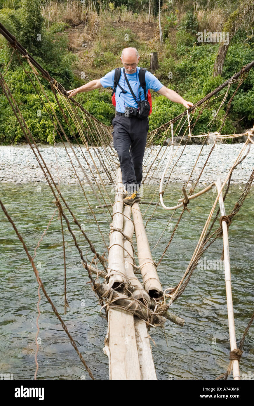 man crossing a narrow suspension bridge Kachin State Myanmar Stock ...