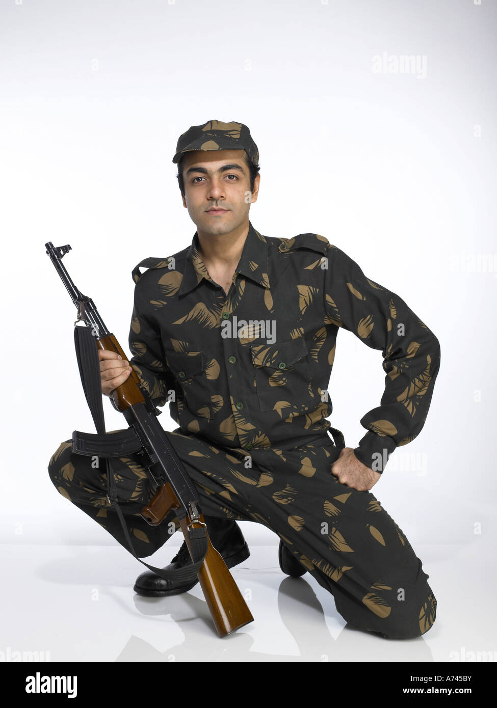 VDA 201716 Indian army soldier sitting on knee holding AK 47 gun MR ...