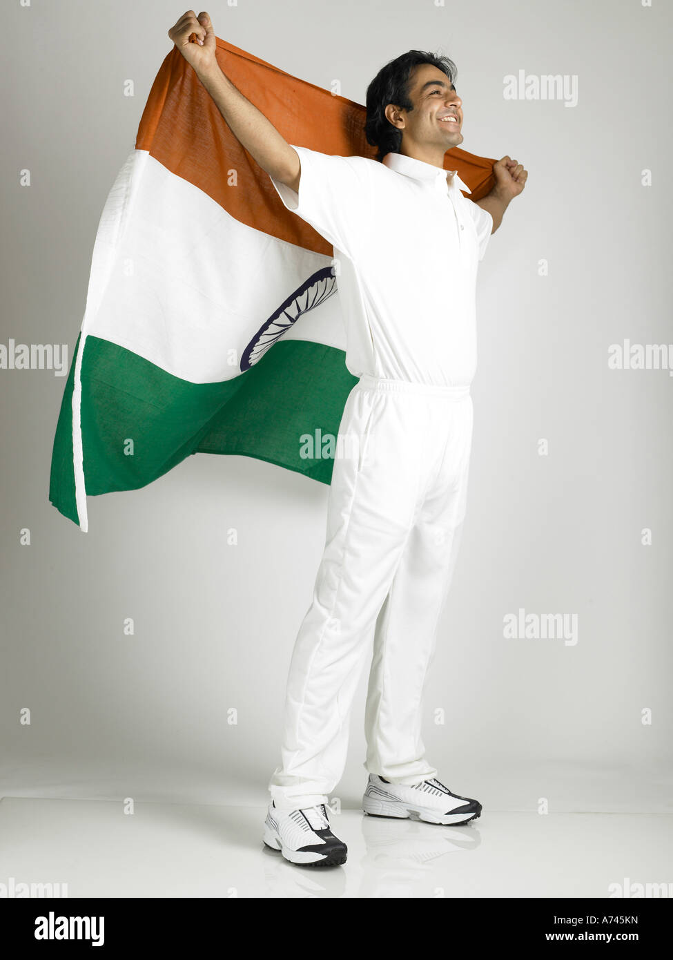 VDA 201797 Indian cricket player holding flag of india on his backside ...