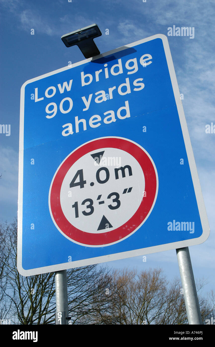 Road sign warning of a low bridge ahead on a road in the uk Stock Photo ...