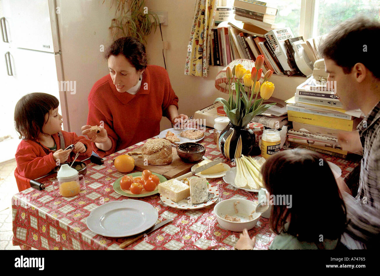 Family at table eating a meal Stock Photo - Alamy