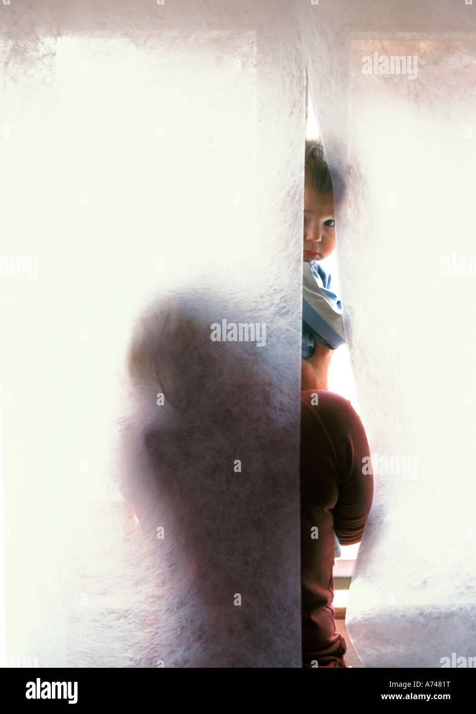 Child by window with mother Stock Photo - Alamy
