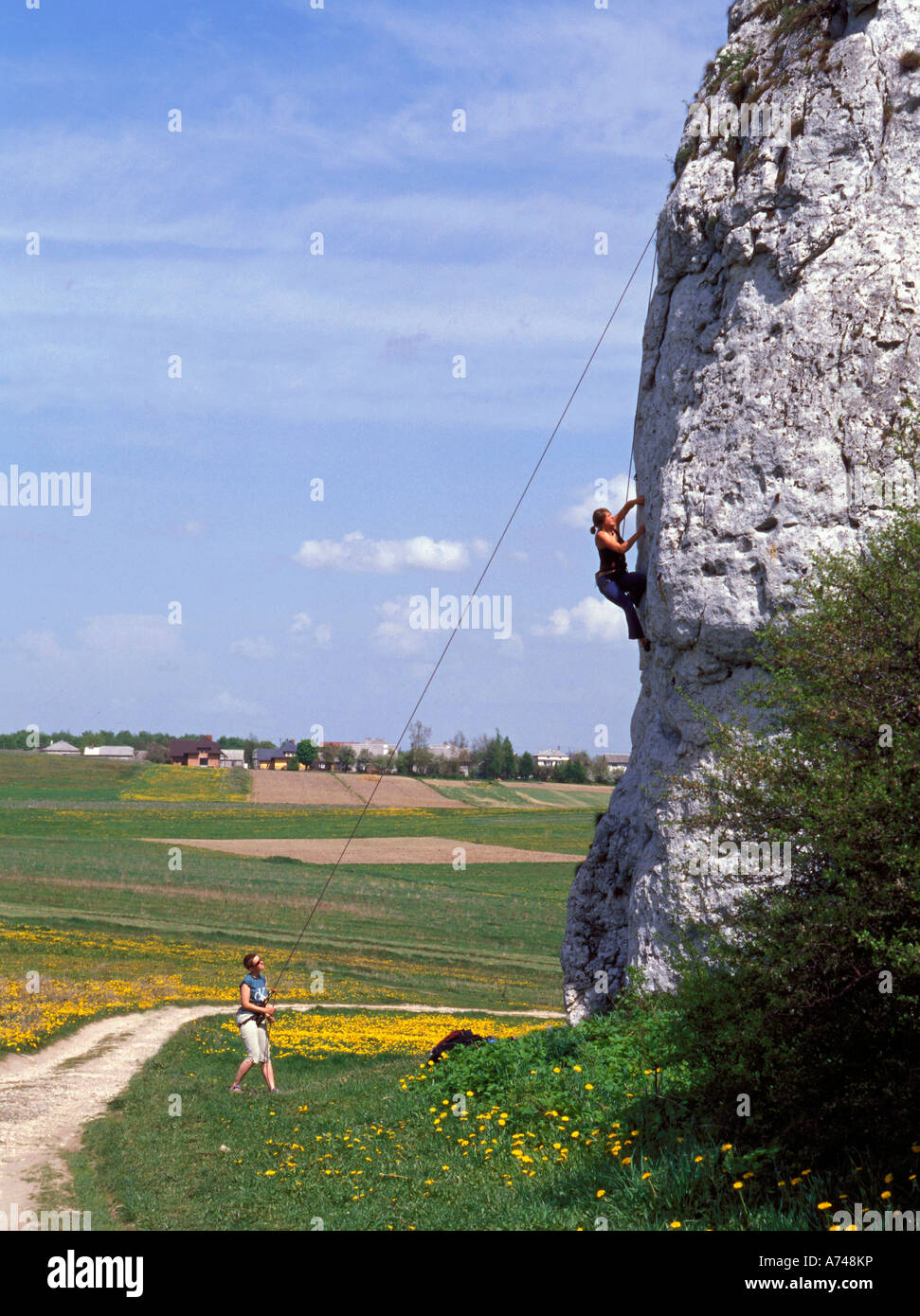 Men climbing on rock Stock Photo - Alamy