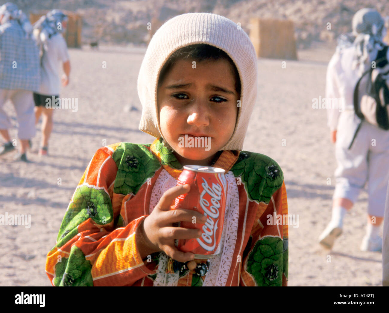 Poor Egyptian girl drinking Coca Cola Stock Photo - Alamy