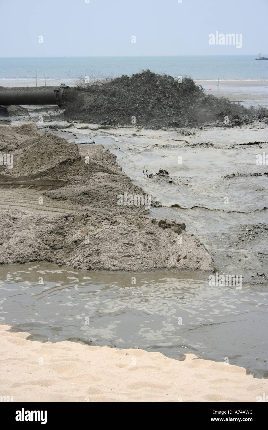 Pouring sand that is suck from the sea on the beach in Malaysia Stock ...