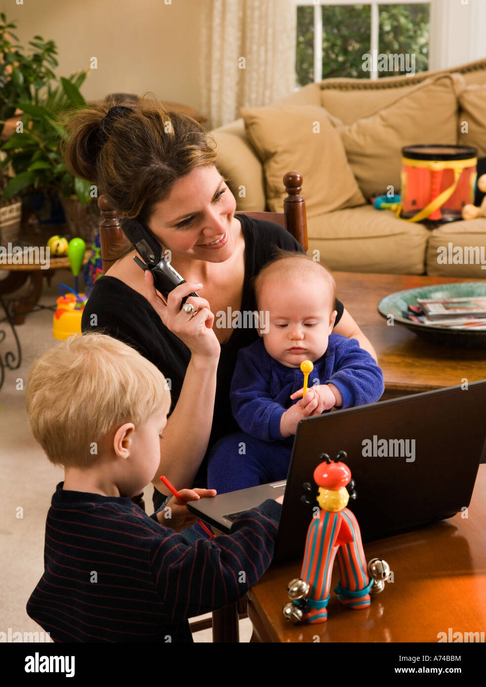 Businesswoman mom shares tasks with children in mobile home office ...